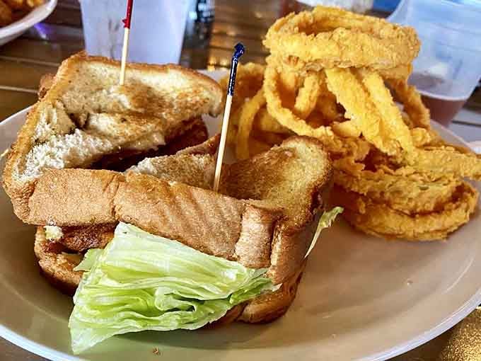 A golden sandwich with crisp onion rings stacked high. Simple, honest, and exactly what lunch is supposed to look like.