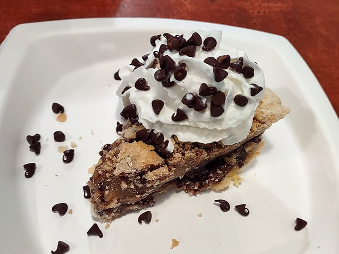 A chocolate chip pie topped with whipped cream that says, "You've earned this. Sit down and enjoy."