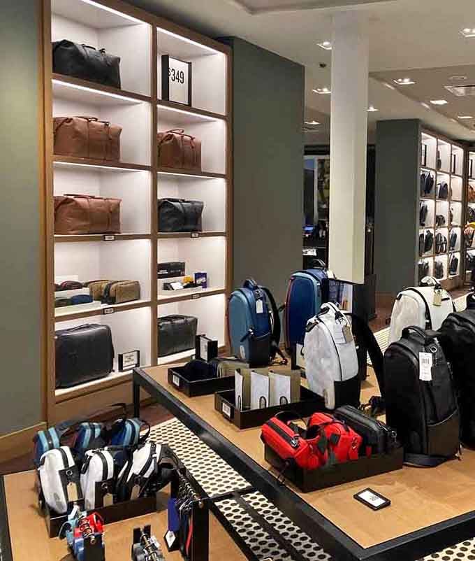 Backpacks and bags displayed like art, ready to carry all your other purchases home in organized fashion triumph.