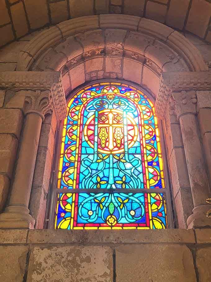 Sunlight through stained glass turns ancient stone into a canvas, and the result is absolutely worth the drive.
