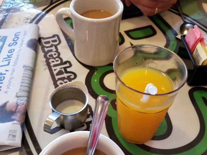 Coffee, orange juice, cream, and a newspaper. This table has everything a perfect morning requires.