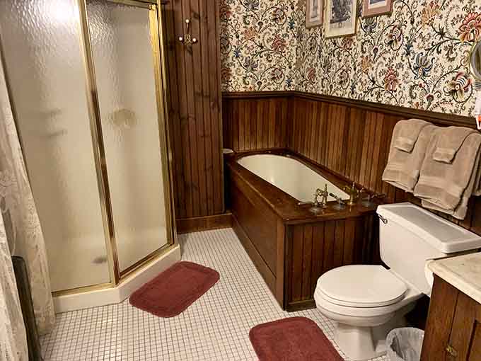 A wood-paneled bathroom with a classic soaking tub and vintage fixtures. Bathing here feels like a legitimate historical experience.