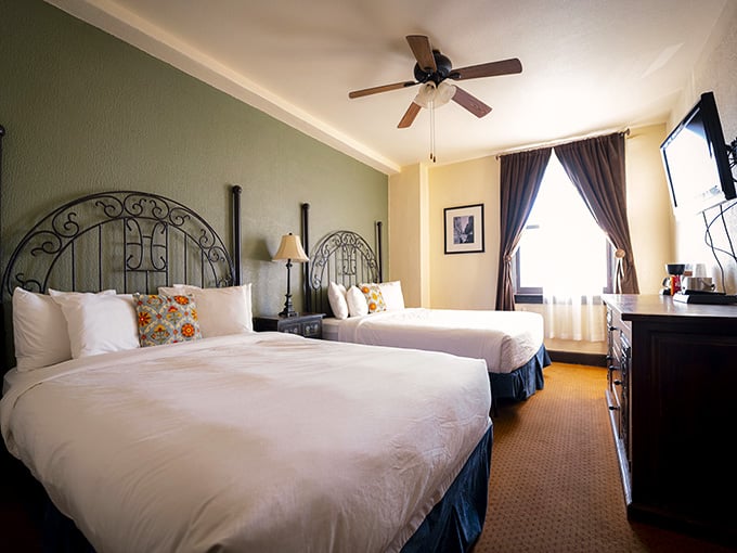 Two beds, scrolled iron headboards, and colorful pillows that somehow make you feel genuinely at home.