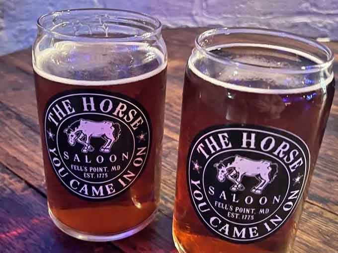 Two pints of amber perfection bearing the saloon's logo, ready to toast centuries of Fells Point history and hospitality.