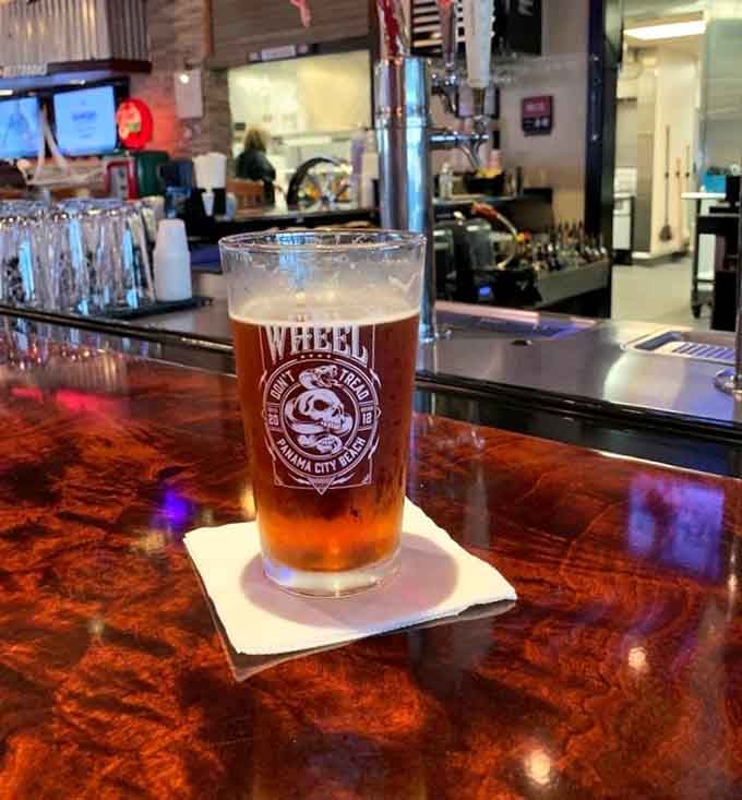 A cold draft beer in a branded Wicked Wheel glass, because some moments deserve to be savored slowly at the bar.