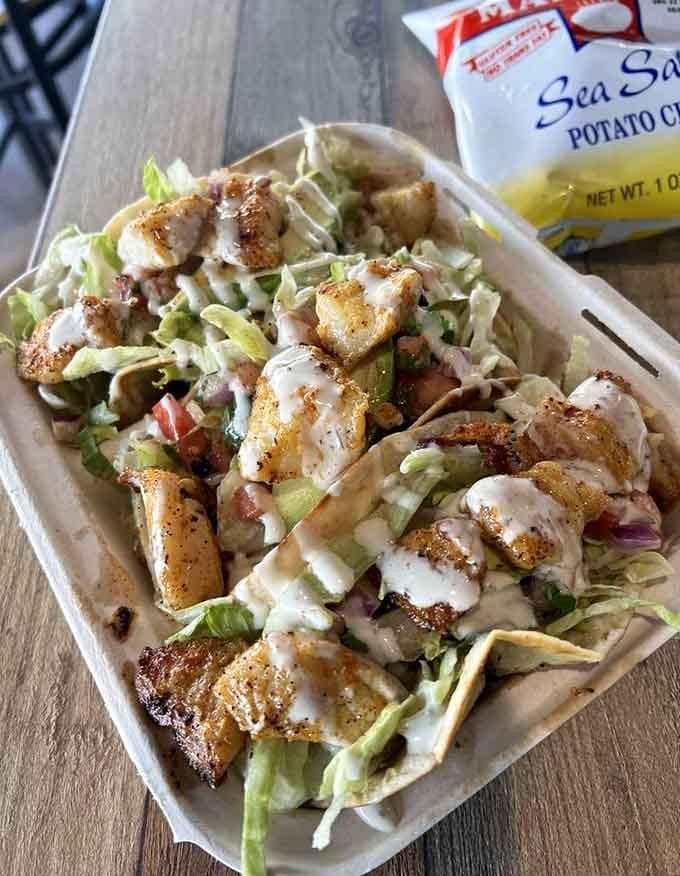 Blackened rockfish tacos piled high and drizzled generously, proof that good things really do come in threes.