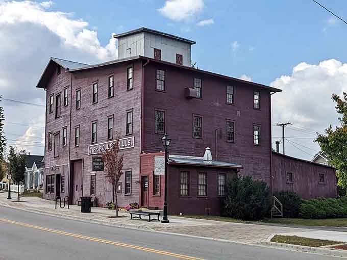 The Tipp Roller Mills building stands tall in deep red, a four-story reminder that this town has serious history baked right into its walls.