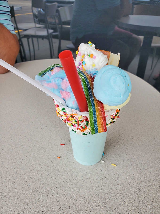 Sprinkles, cotton candy, a rainbow candy stick, and a scoop of blue ice cream. Pure, unapologetic joy in a cup.