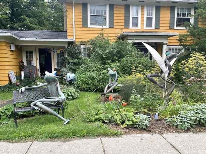 Life-sized frog sculptures lounging in a garden so gloriously overgrown it feels like the yard itself decided to become the art installation.