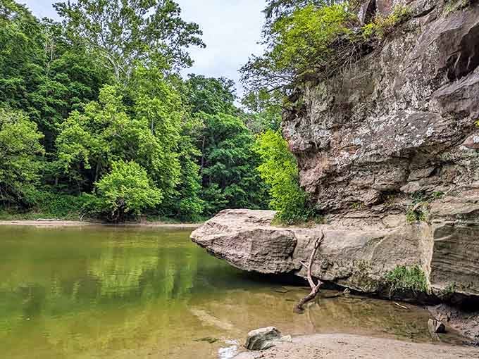 Ancient sandstone juts over the glassy creek like geology decided to make its boldest statement here.