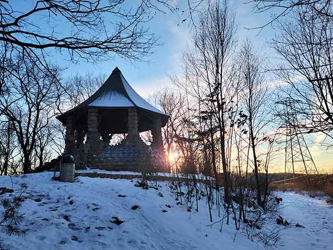 Snow-dusted and glowing at sunset, this old stone pavilion looks like something straight out of a holiday movie nobody made yet.