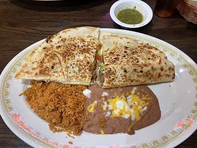 The King's Quesadilla arrives golden and grilled, with rice and beans alongside, ready to make your afternoon considerably better.