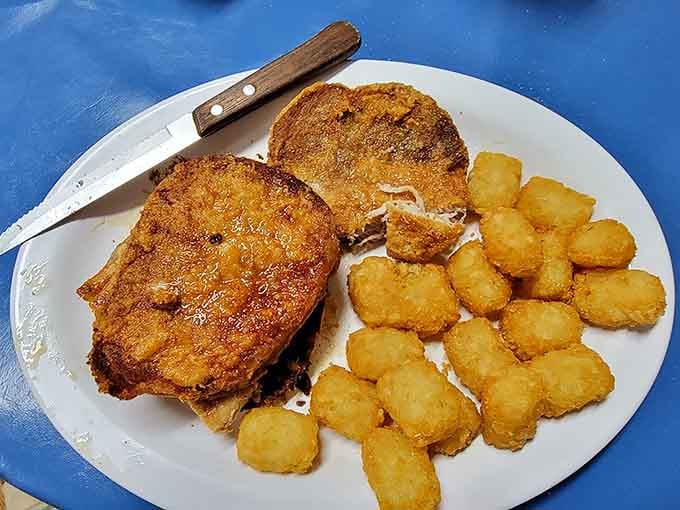 Breaded pork chops with a golden crust, served with tater tots. Comfort food that doesn't apologize for anything.