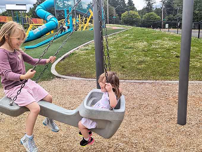 Side by side on a tandem swing, these two are sharing a moment that no screen could ever replicate.