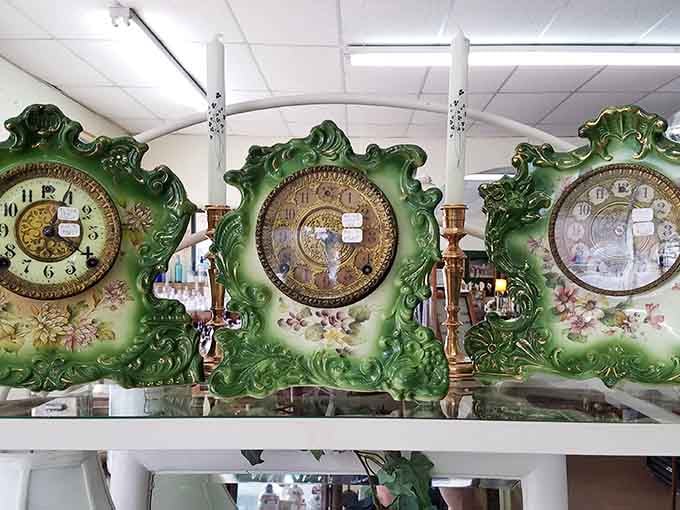 Three ornate green and gold mantel clocks lined up together, because one statement piece is never enough.
