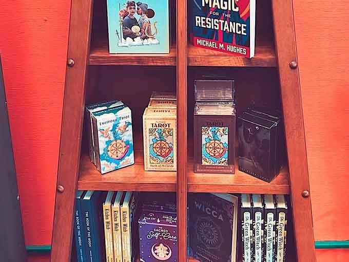 Tarot decks and mystical books stacked neatly on a wooden shelf. Your future self is already browsing this section.