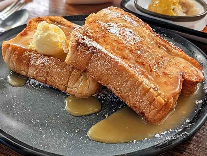 Golden, buttery French toast dusted with powdered sugar, the kind of breakfast that makes waking up early feel completely worth it.