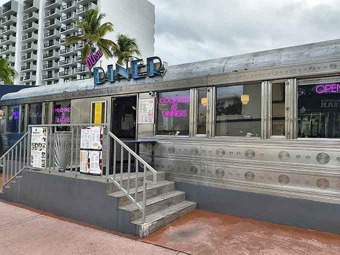 A gleaming silver Pullman car parked on Washington Avenue with neon signs glowing? Miami Beach just got more interesting.