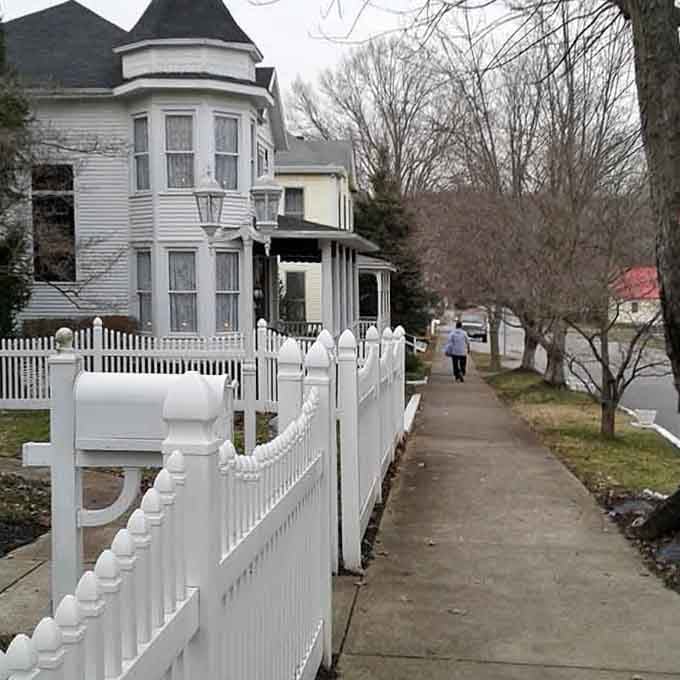 A Victorian turret, a crisp white picket fence, and a lone figure strolling the sidewalk, Augusta's residential streets are pure, unhurried poetry.