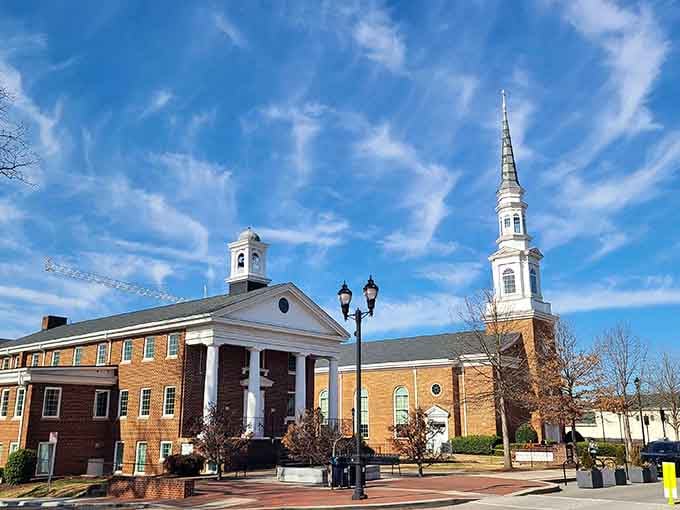 A soaring white church steeple and a stately brick building share the Cary skyline in a picture of classic Southern grace.
