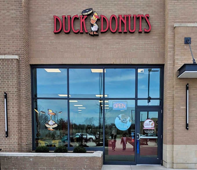 That cheerful duck mascot perched above the door at Duck Donuts is basically the happiest greeter in all of Westerville.