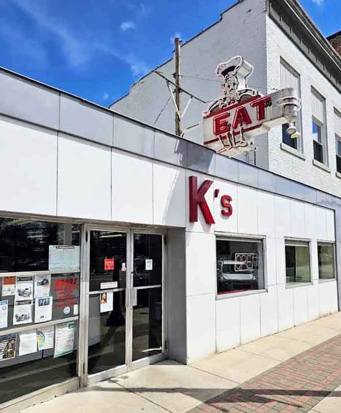 That cartoon chef holding an "EAT" sign above K's is basically the most honest piece of advice in Troy.