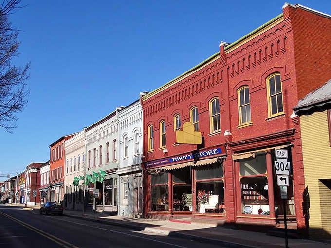 These painted storefronts pop against blue skies, each color choice telling you someone cares about keeping history vibrant.