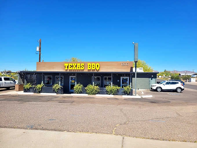 Bold yellow letters against black walls announce Texas-style BBQ with the confidence of a place that delivers.