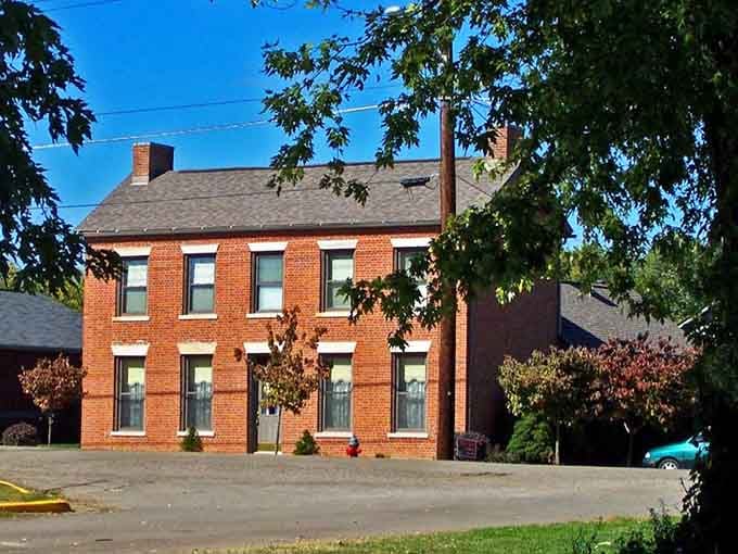 This sturdy two-story brick home in Piketon stands quietly beneath the trees, carrying its history with understated grace.
