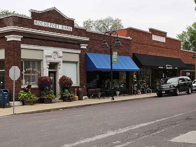 The old Rocheport Bank building anchors this charming block with quiet authority, while colorful flower boxes and a blue awning keep things cheerful.