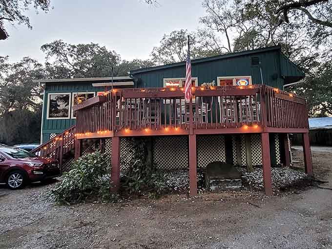 Warm string lights wrapped along the deck railing make Russell's glow like a cozy invitation on a cool evening.