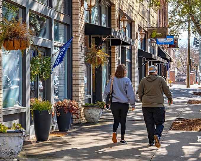 Shelby's autumn sidewalk scene, with two people strolling past warm storefronts, looks like the opening shot of a very good movie.
