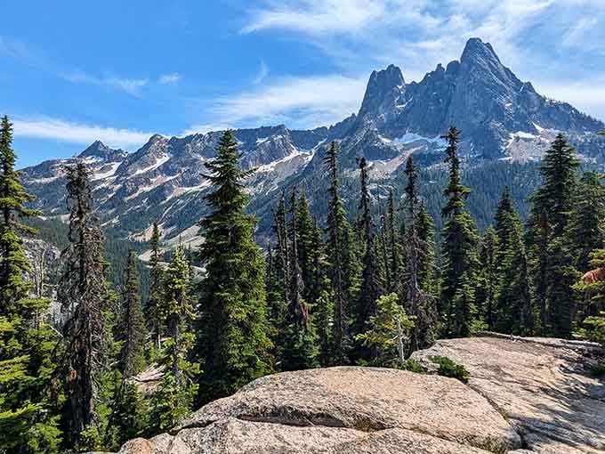 Liberty Bell Mountain rising sharp and jagged above a forest of dark conifers, looking every bit like a scene from a legend.