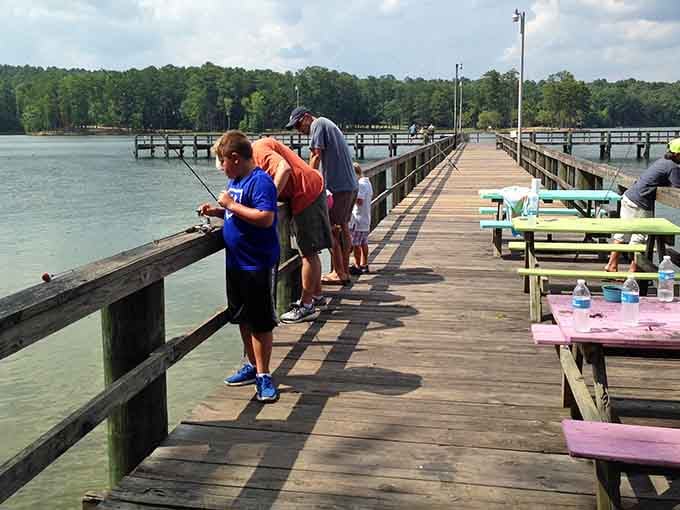 Three generations on one pier, lines in the water, colorful picnic tables nearby &mdash; Wind Creek knows exactly what summer should feel like.