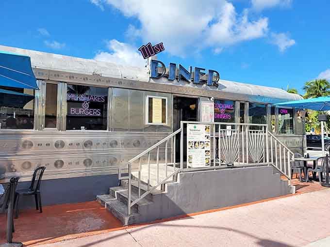 Under a bright blue sky, the 11th Street Diner's riveted stainless steel exterior shines like a classic American dream.