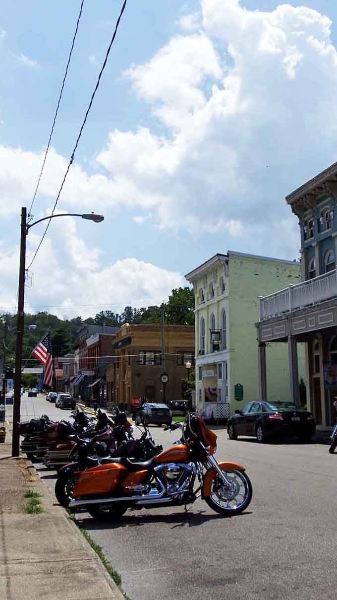 Harley-Davidsons lined up on Augusta's main street like a chrome-plated welcome committee, with that gorgeous pale-yellow building standing proud behind them.
