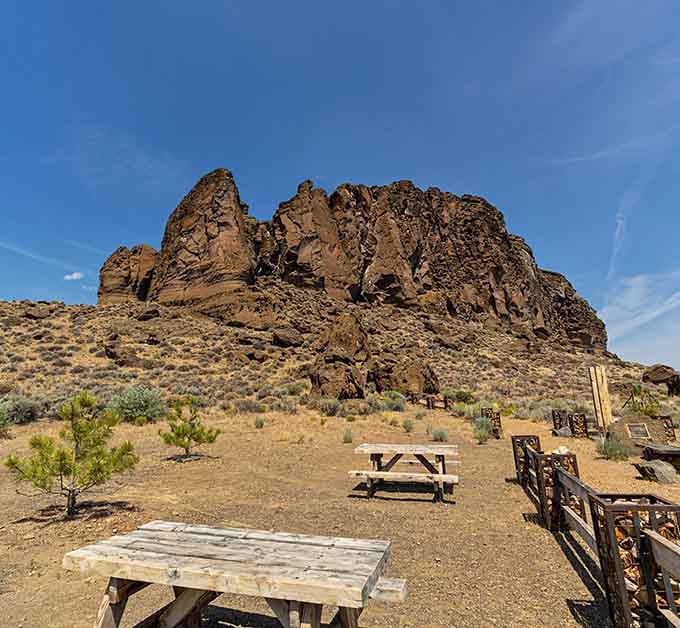 The picnic area sits in the shadow of towering cliffs that have watched over this landscape for millennia.