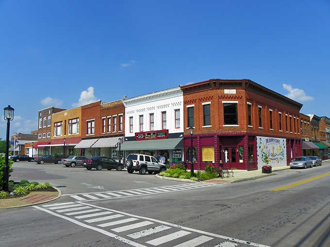 Flower planters and striped awnings show that someone here still believes in making everyday spaces beautiful for their neighbors.