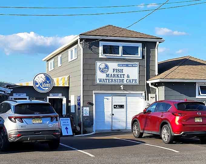 That bold Klein's Fish Market and Waterside Cafe sign catches the afternoon light like it knows exactly how good the seafood inside is.