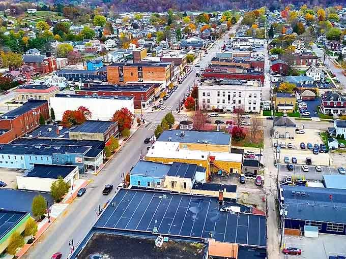 Logan's autumn canopy blazes orange and red from above, framing a downtown that clearly peaked in the best possible way.