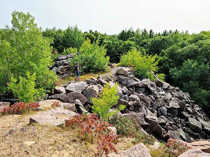 One lone hiker picks his way across a boulder ridge, looking like he wandered into a nature documentary.