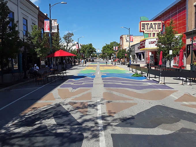 Front Street's rainbow street mural leads your eye straight to the glowing State Theatre sign, a perfect Traverse City welcome mat.