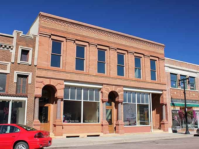That warm terracotta sandstone facade with its graceful arched storefront columns makes this Worthington building look like it belongs in a much larger city entirely.
