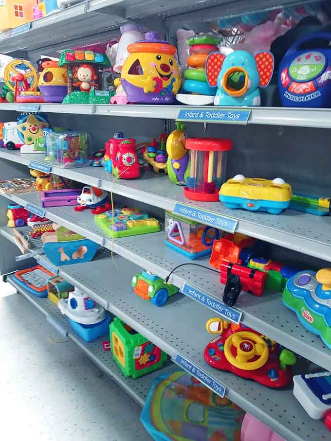 Bright, cheerful infant and toddler toys filling every shelf, the kind of colorful chaos that makes grandparents smile and toddlers absolutely lose their minds.
