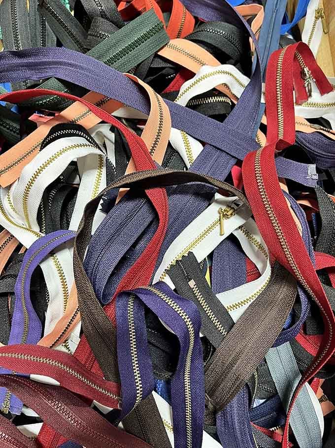 A glorious tangle of zippers in every color, the tiny hardware heroes that hold our creative worlds together.