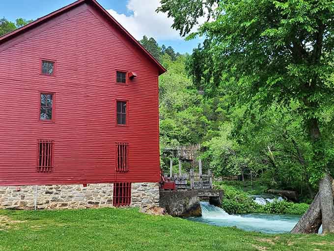 The bold red mill building rising from its stone foundation is a genuine Ozark landmark worth celebrating.