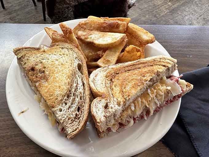A Reuben stacked with corned beef and sauerkraut, toasted golden, served with thick-cut fries. Lunch just got serious.