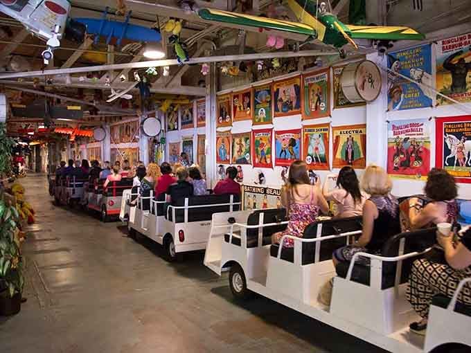 The tram rolls past circus posters and hanging artifacts, turning a museum visit into a genuine adventure.