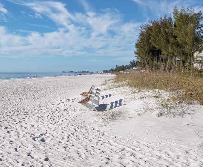 Beach chairs sitting on blindingly white sand, with the whole Gulf stretching out ahead. Your name is written all over that seat.