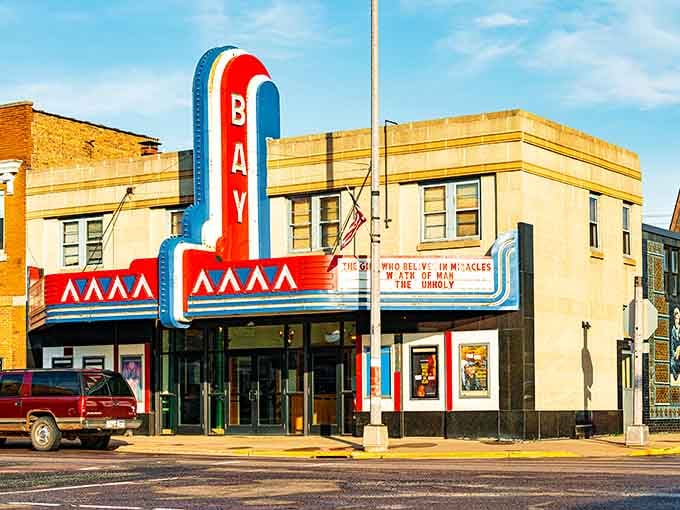 The Bay Theater's vintage marquee glows like a beacon, proving small towns do entertainment with serious style.